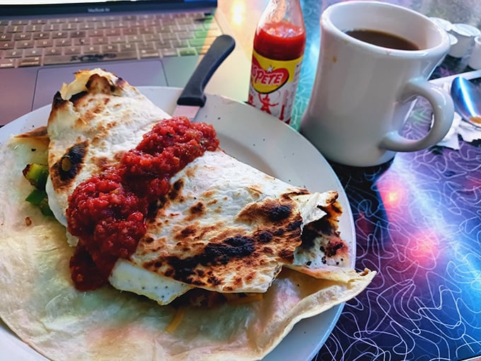 This quesadilla, charred in all the right places and oozing with melted cheese, comes with a side of coffee—breakfast and lunch colliding in delicious harmony.