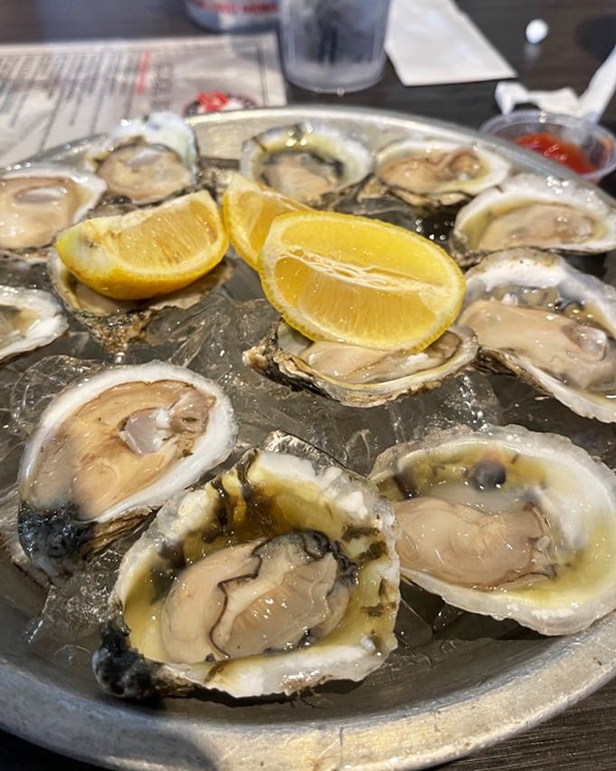 Raw oysters arranged like a briny clock face, with lemon wedges marking happy hour. Nature's perfect appetizer awaits.