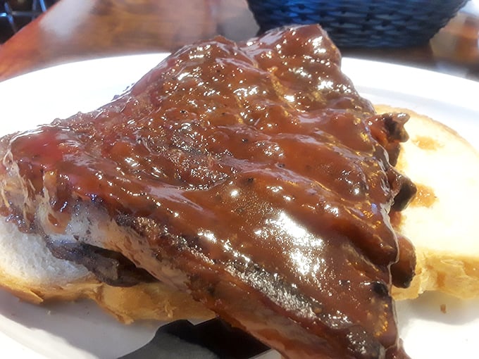 Ribs so tender they practically surrender to gravity, smothered in a sauce that should be bottled and sold as liquid happiness.