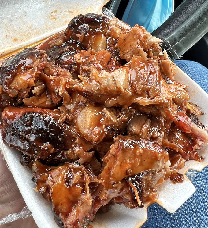 Saucy rib tips glistening in their takeout container – the kind of messy perfection that justifies keeping extra napkins in your glove compartment.