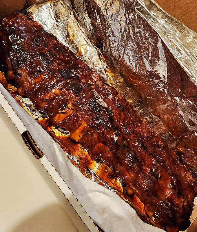 Fall-off-the-bone ribs slathered in sauce that would make a napkin manufacturer weep with joy. Finger-licking required, no exceptions.