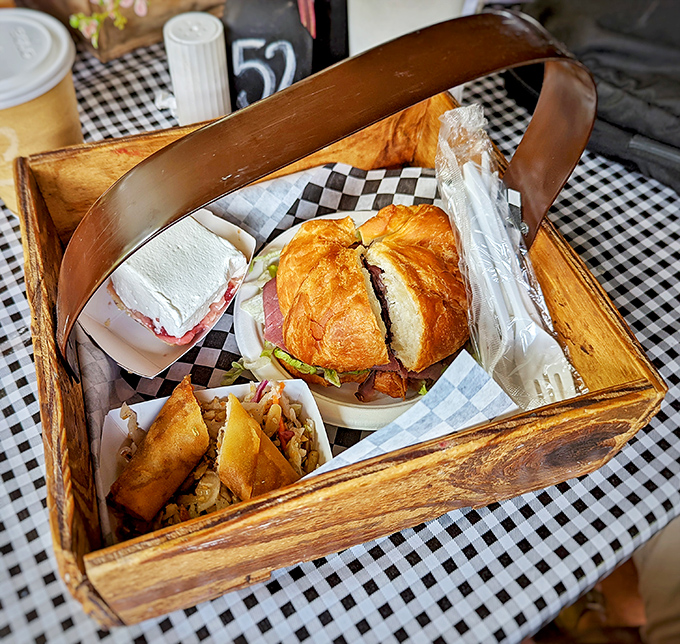 A feast fit for royalty: roast beef sandwich accompanied by sides and what appears to be a heavenly cream-topped dessert waiting patiently for its moment.