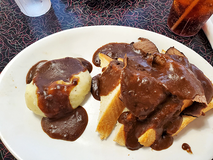 This hot roast beef sandwich isn't messing around. The gravy has clearly made a solemn vow to cover every available surface.