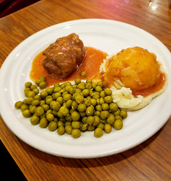 Old-school comfort: A tender rolled steak swimming in rich gravy alongside mashed potatoes and peas&mdash;like a hug from your grandmother.
