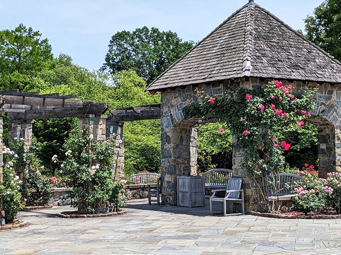 This stone pavilion draped in climbing roses could convince even the most dedicated city-dweller that country life has its charms.