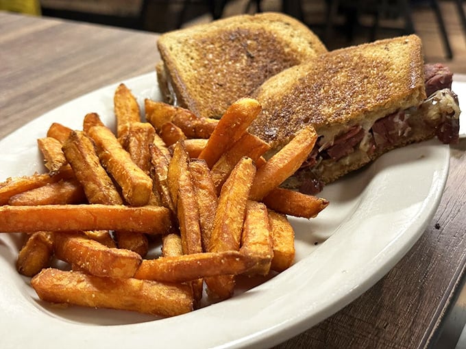 A Reuben sandwich that would make New York jealous, paired with sweet potato fries that somehow make you feel virtuous about your indulgence.