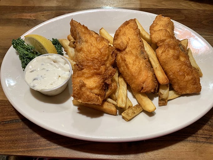 Fish and chips done right: crispy golden armor protecting flaky white fish, with a side of perfectly golden fries.