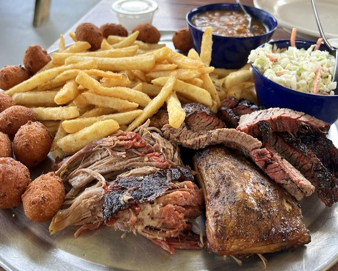 When decision-making becomes impossible, this platter saves the day. Pulled pork, brisket, chicken, and all the fixings create a barbecue tour on one plate.