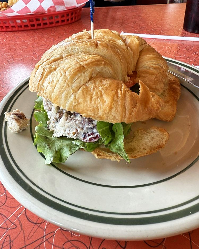This croissant sandwich isn't just lunch &ndash; it's edible engineering, with layers of chicken salad and crisp lettuce creating perfect harmony.