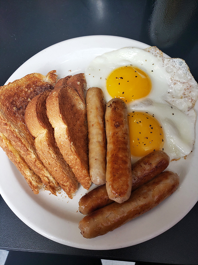 Sausage links standing at attention alongside sunny-side-up eggs and toast. This plate doesn't just say "good morning"&mdash;it shouts it.