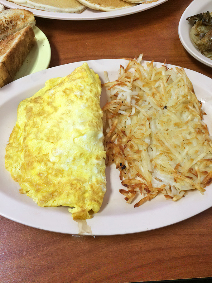 The classic American breakfast plate: fluffy omelet meets crispy hash browns. A duo more iconic than Batman and Robin, and twice as satisfying.