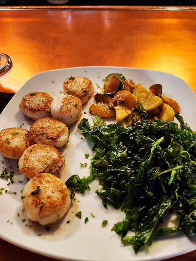 Perfectly seared scallops that would make Neptune himself swim to shore, accompanied by greens that actually make you want to eat vegetables.
