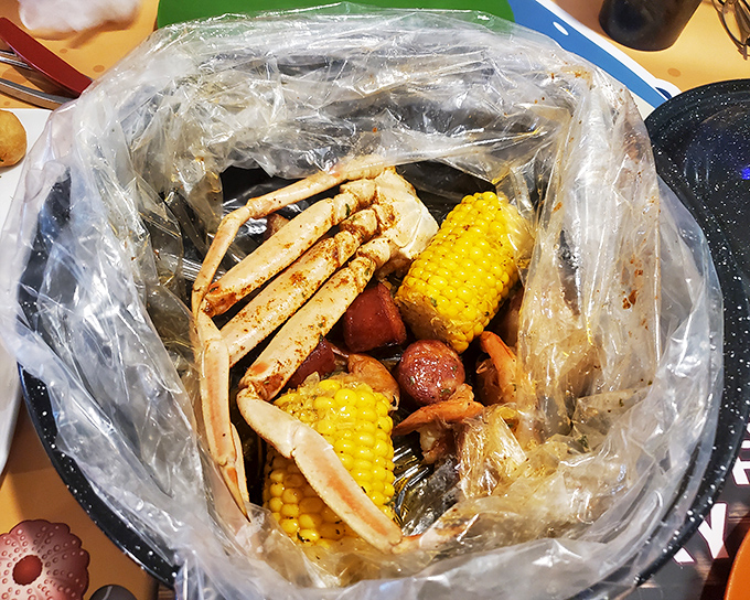The seafood boil arrives like a treasure chest&mdash;snow crab legs, corn, and potatoes swimming in seasoned glory. Roll up your sleeves, this gets personal.