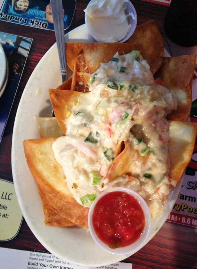 Seafood nachos that make you question why you ever settled for just cheese. A mountain of tortilla chips supporting seafood's greatest hits.