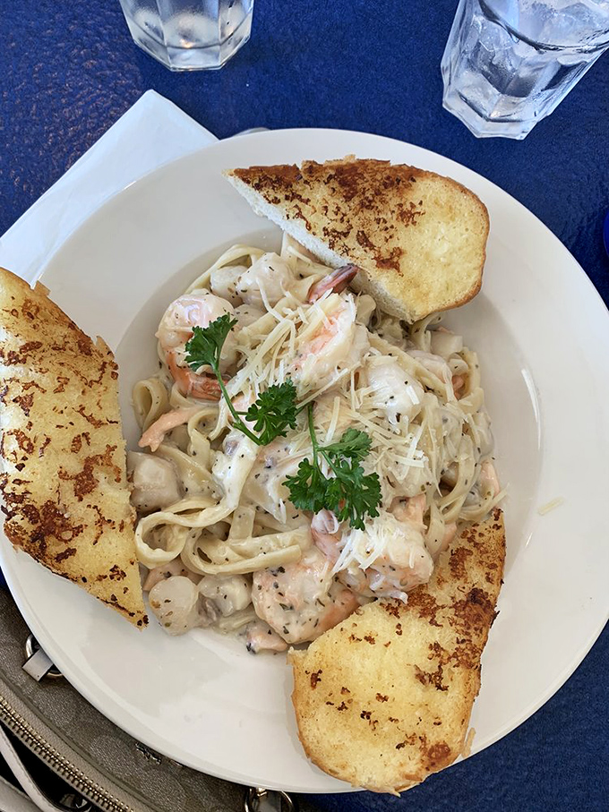 Seafood pasta that would make an Italian grandmother nod in approval. Those toasted garlic bread slices are the perfect supporting actors.