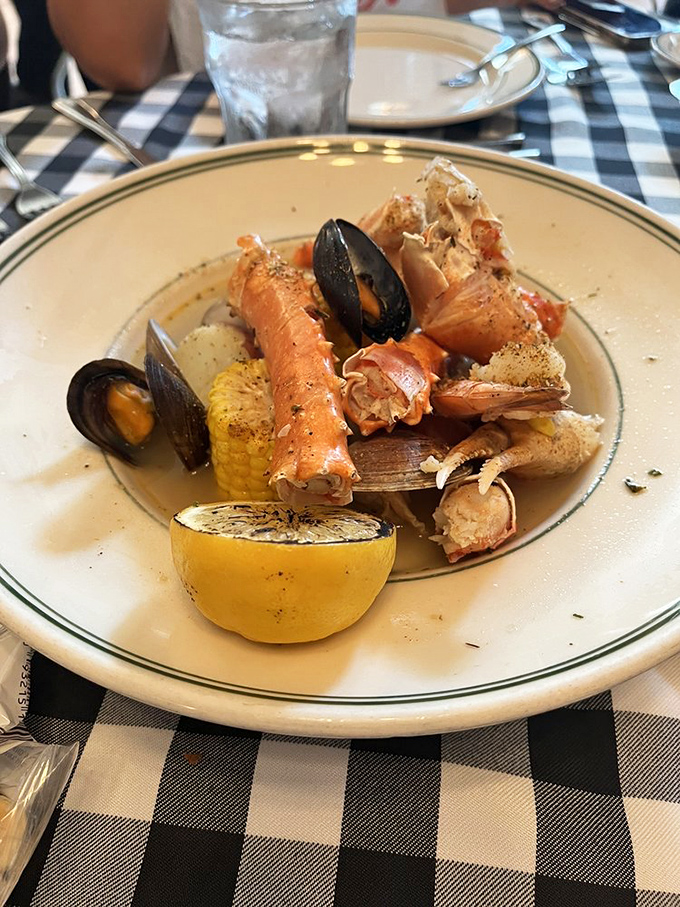 A seafood symphony of king crab legs, mussels, and corn, with lime wedges conducting the zesty finale.