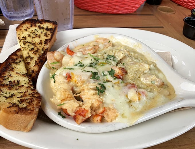 Seafood swimming in buttery goodness with garlic bread standing by for the essential sauce-sopping duty. A dish worth crossing state lines for!