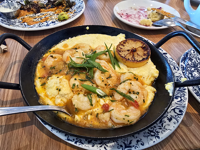 Shrimp and grits served in a skillet hot enough to make you forget winter exists. That charred lemon isn't just garnish&mdash;it's an exclamation point.