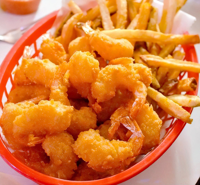 Perfectly golden shrimp nestled against crispy fries—a basket of simple pleasures that makes fancy seafood towers seem unnecessarily complicated.