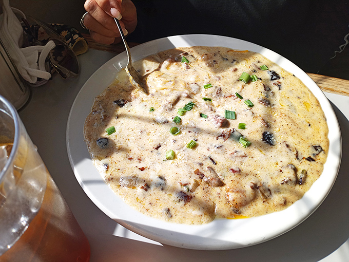 The legendary shrimp and grits&mdash;creamy, cheesy perfection studded with plump shrimp and bacon, garnished with green onions for that perfect finish.
