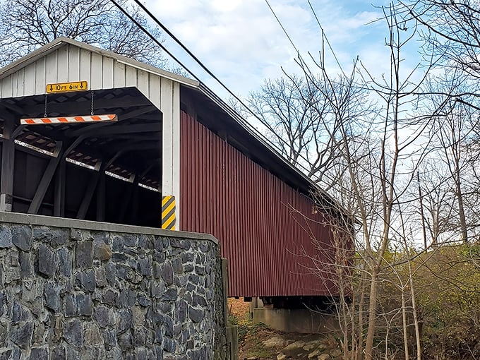 The stone foundation anchors this floating piece of history to Pennsylvania soil. Winter's bare trees frame the structure like nature's own museum display.
