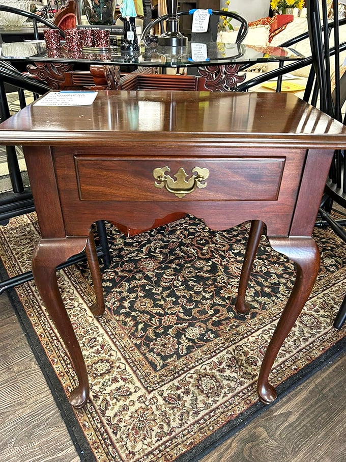 Queen Anne legs and brass hardware&mdash;this side table has seen more history than most history books. Elegant craftsmanship awaits its next chapter.