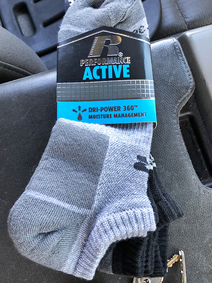 Athletic socks still sporting their original tags—proof that someone's impulse purchase becomes your savvy deal with moisture-wicking technology intact.
