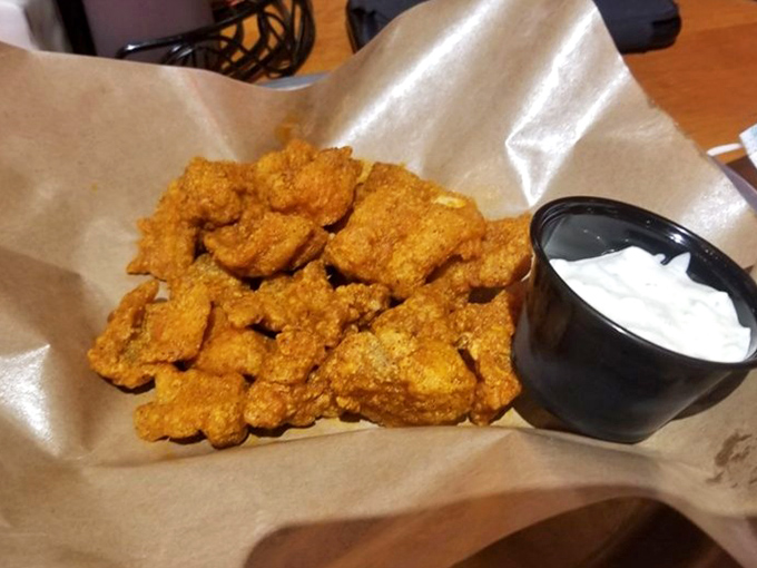 Golden-fried catfish nuggets with a side of cool dipping sauce. Mississippi River cuisine meets Southern frying expertise in one perfect basket.