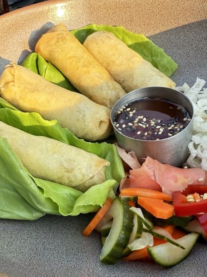 These spring rolls aren't just appetizers&mdash;they're crispy little envelopes of joy, served with a dipping sauce that'll make you consider drinking it straight.