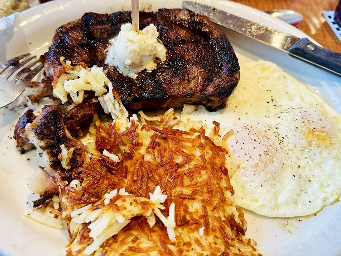The holy trinity of breakfast: perfectly seared steak, eggs with sunshine-yellow yolks, and hash browns crisped to golden perfection.