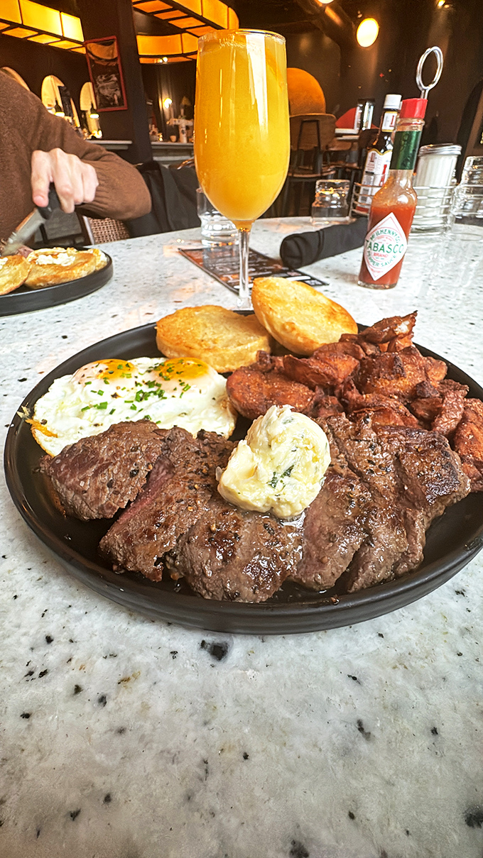Steak and eggs: the breakfast of astronauts and ambitious mortals. That mimosa stands by, ready for weekend mission control.