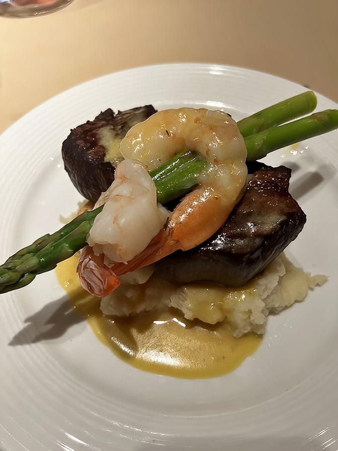 Steak and shrimp perched atop mashed potatoes like royalty on a cloud. The asparagus is just trying to keep things somewhat virtuous.