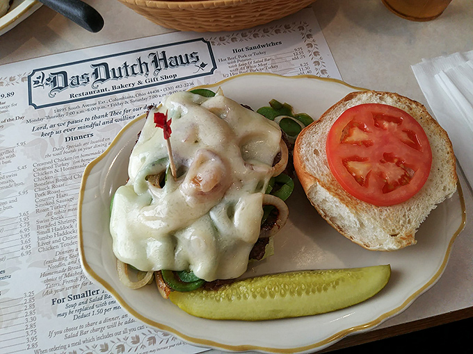 This isn't just a sandwich&mdash;it's a masterpiece of melted cheese and savory goodness, complete with a pickle sentinel standing guard.