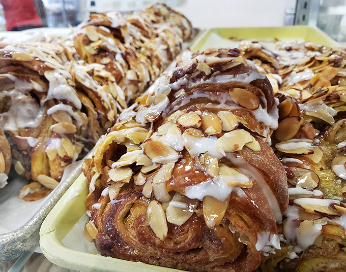 These almond-topped sticky buns aren't just breakfast; they're an argument for dessert at 8 AM that no reasonable person could refute.
