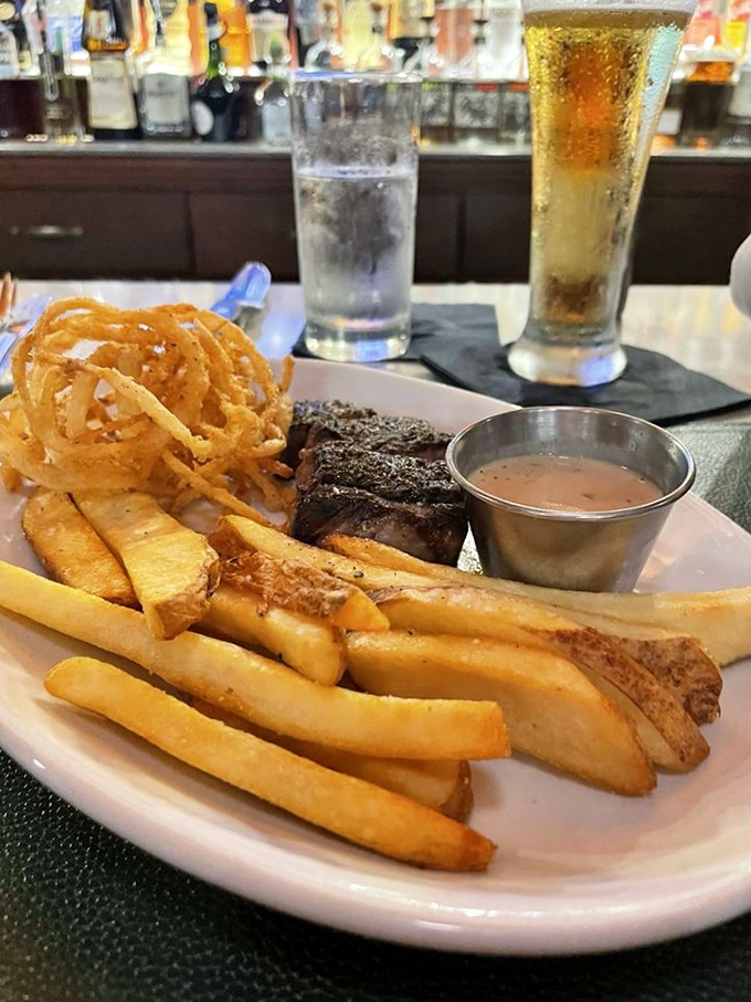 This isn't just dinner&mdash;it's a carnivore's dream vacation. Steak, fries, and onion rings: the holy trinity of comfort food, elevated to art form.