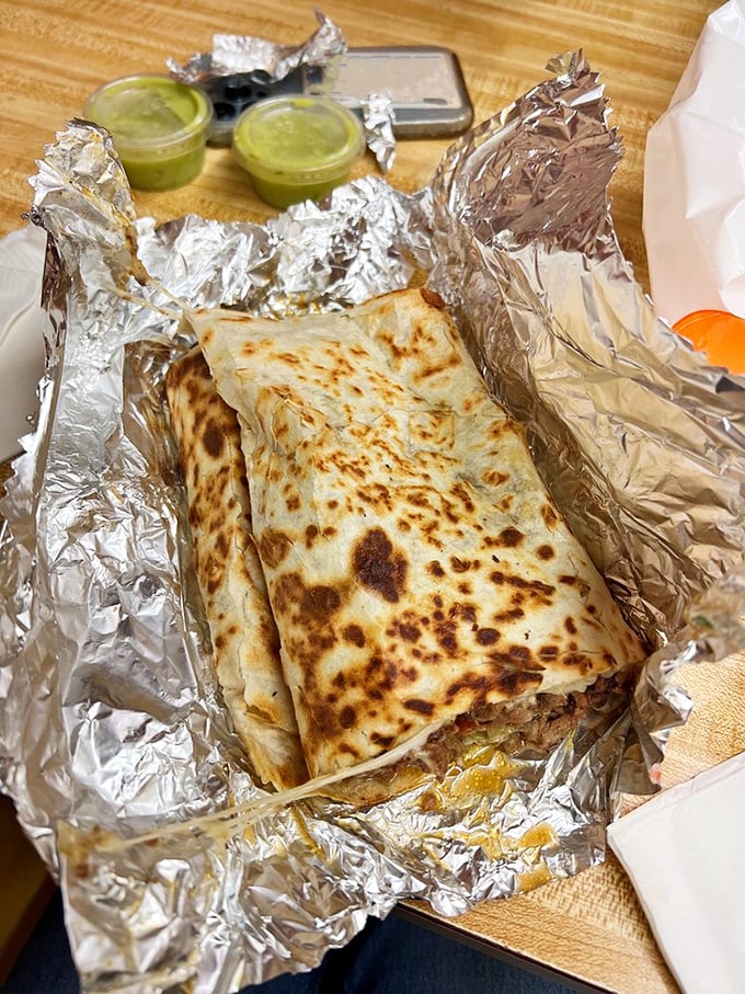 The quesadilla that launched a thousand food pilgrimages, nestled in its silver foil throne with salsa verde courtiers standing by.