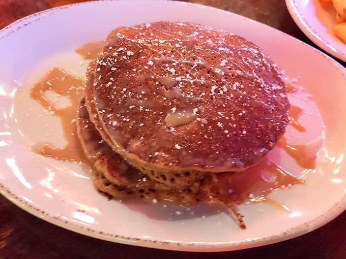 Sweet potato pancakes drizzled with syrup and dusted with powdered sugar&mdash;like autumn decided to throw itself a party on a plate.