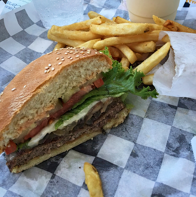 Half-eaten because waiting to take a photo required superhuman restraint&mdash;a burger that demands immediate attention rather than Instagram patience.