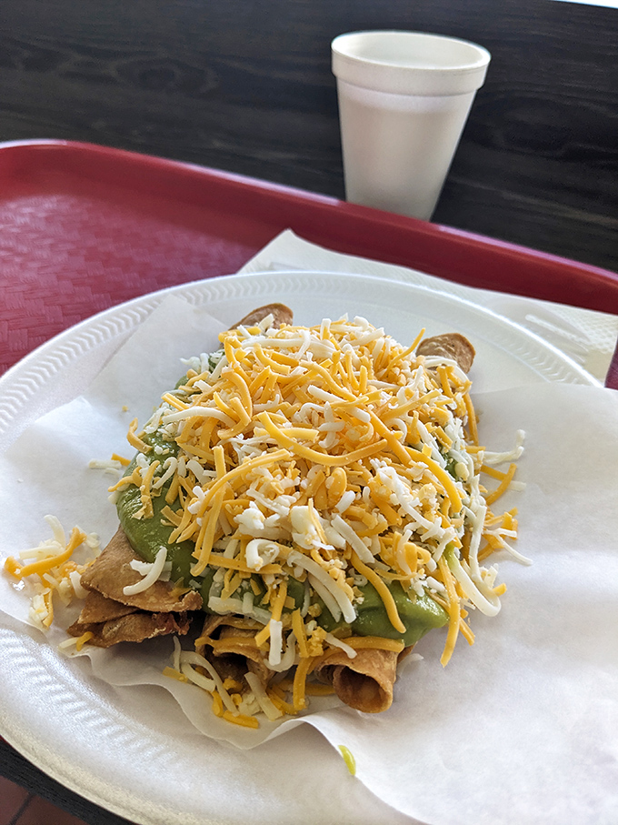 Taquitos drowning in a blizzard of cheese. These crispy rolled tacos are wearing their formal attire&mdash;dressed up with enough toppings for a fiesta.