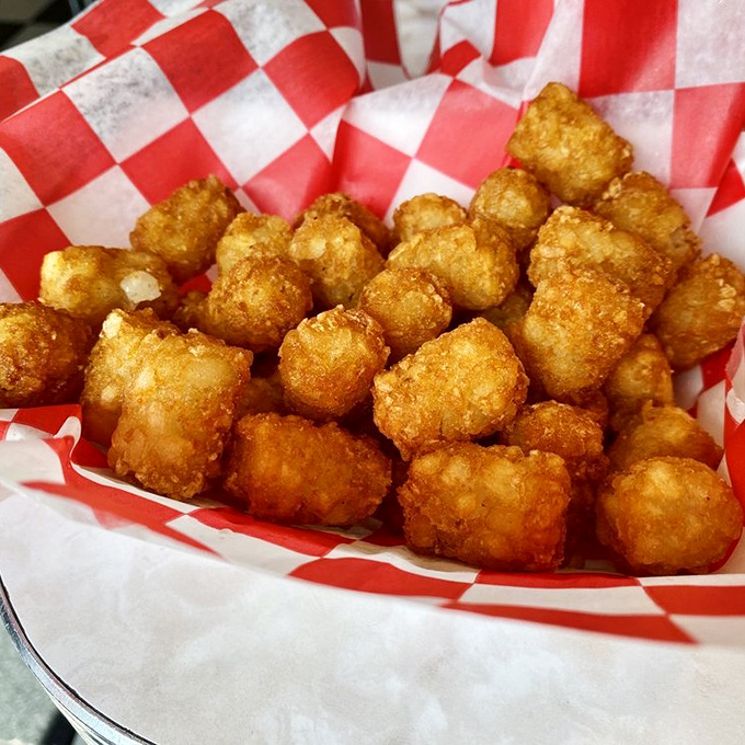 Golden tater tots that crunch like autumn leaves, nestled in their checkered paper like precious jewels from the deep fryer's treasure chest.