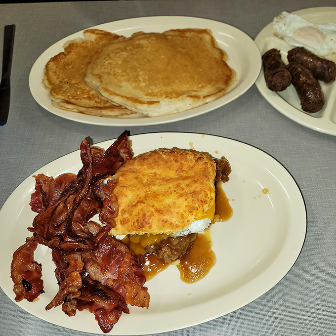 Southern breakfast architecture at its finest&mdash;a monument to gravy engineering with crispy bacon sentries standing watch.