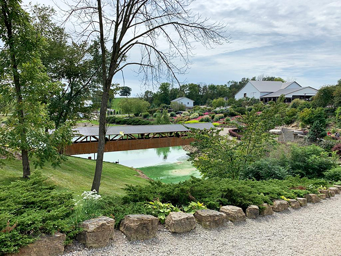 A covered bridge reflects in still waters, creating a perfect symmetry that feels like stepping into a painting rather than a photograph. 