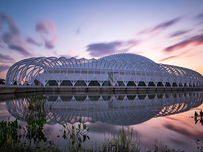 The IST building reflects at sunset like nature and architecture decided to collaborate on a masterpiece. Even the clouds showed up to admire it.
