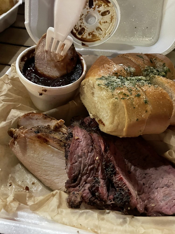 When tri-tip and chicken share a plate, it's not just a meal—it's a summit meeting of smoke-kissed perfection with garlic bread as mediator.