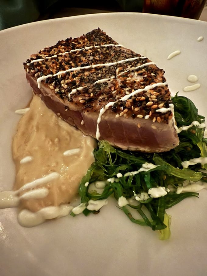 Sesame-crusted tuna that's seared just right&mdash;still blushing pink inside&mdash;resting on a bed of greens like it's taking a well-deserved vacation.