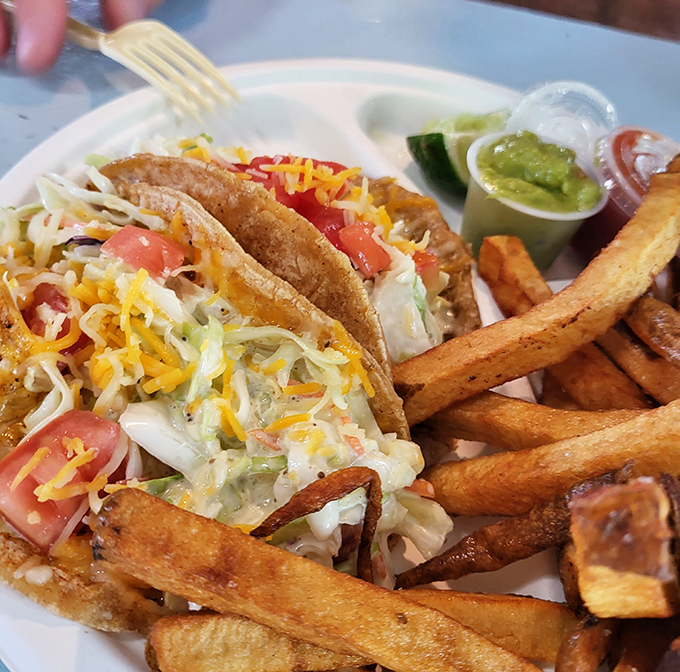 Fish tacos loaded with fresh fixings and crispy fries &ndash; proof that sometimes the simplest meals create the most profound happiness.