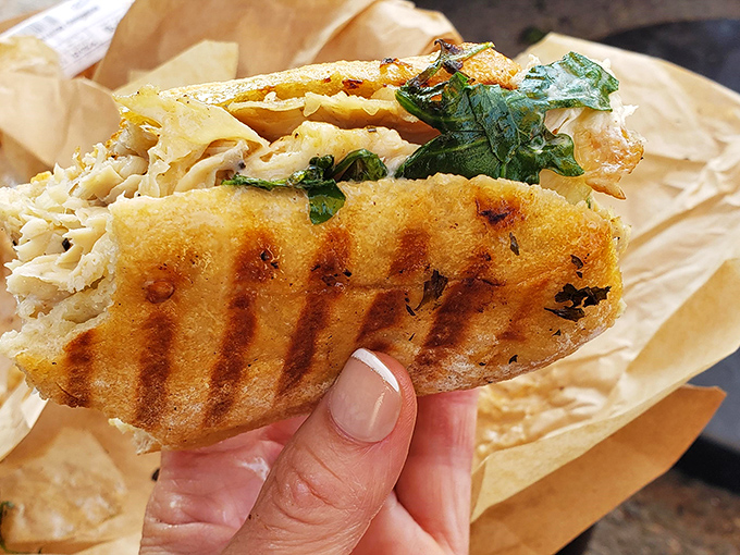 Golden-grilled bread cradles what appears to be chicken or turkey – proof that simplicity executed perfectly beats complexity every time.