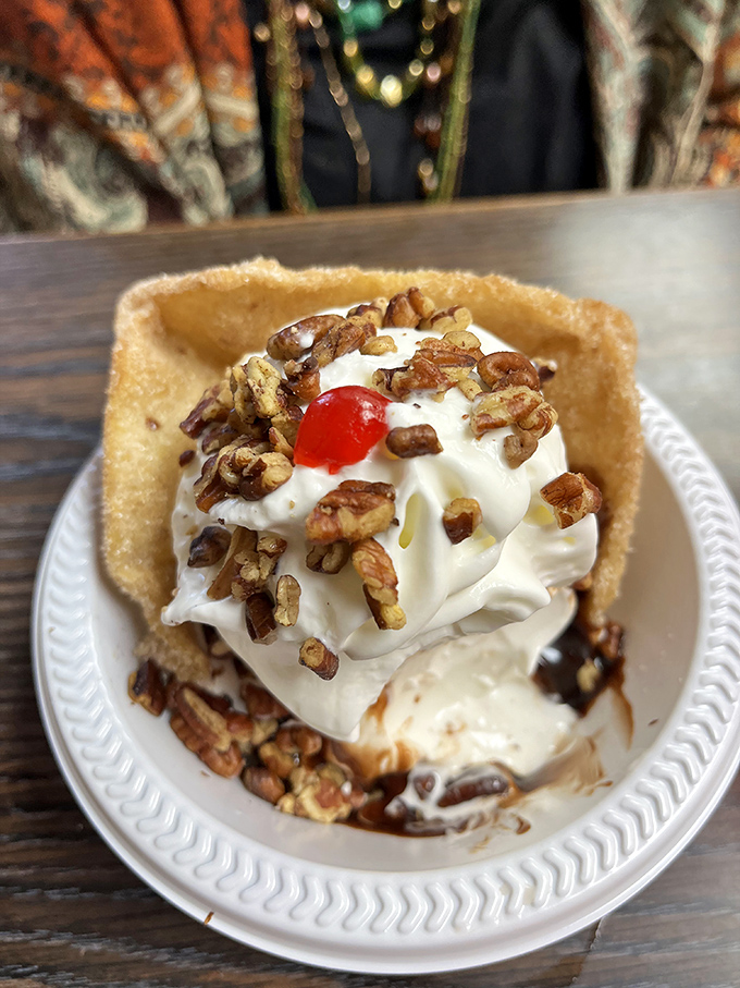 This turtle sundae isn't just dessert, it's architecture. The pecans, caramel, and ice cream create a delicious skyline that would make Frank Lloyd Wright jealous.