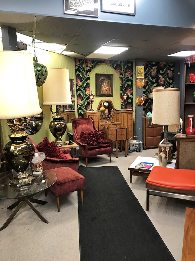This vignette screams 1970s luxury with velvet chairs that have seen more interesting conversations than most therapists. Tropical wallpaper not included in therapy sessions.