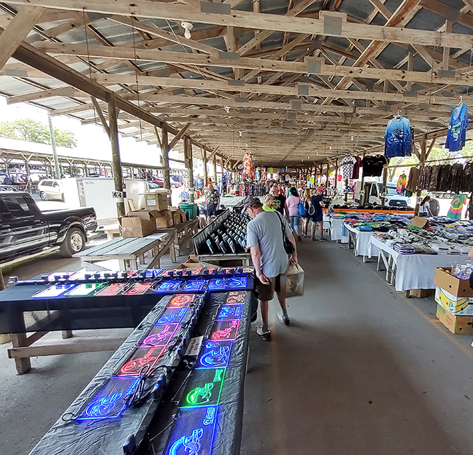The covered vendor alley stretches like a runway of possibilities. Those neon signs might just be the conversation piece your game room needs.